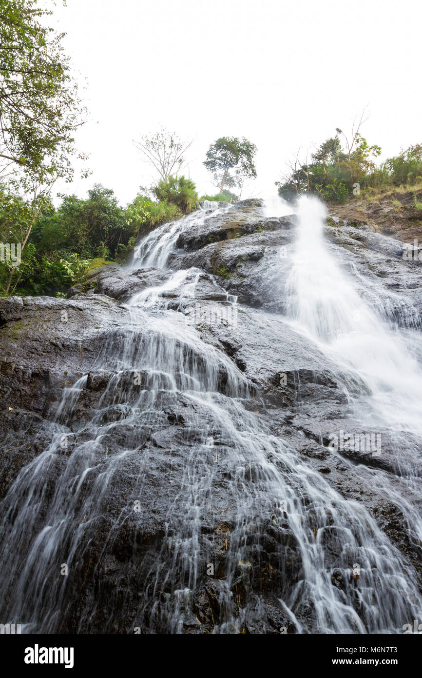 tall rock cliff with a waterfall running down it in tropical Costa Rica ...