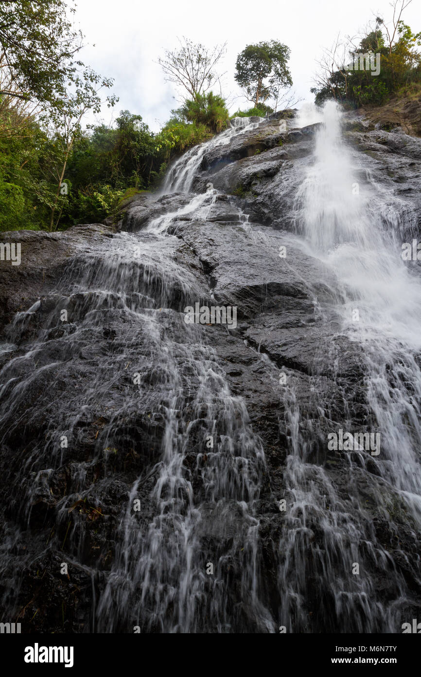 tall rock cliff with a waterfall running down it in tropical Costa Rica Stock Photo - Alamy