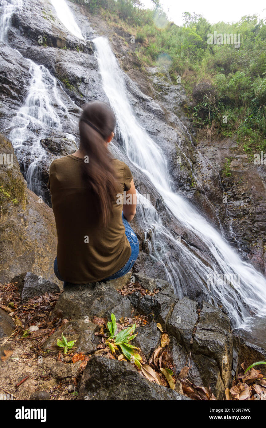woman practicing mindful meditation while sitting in front of a ...