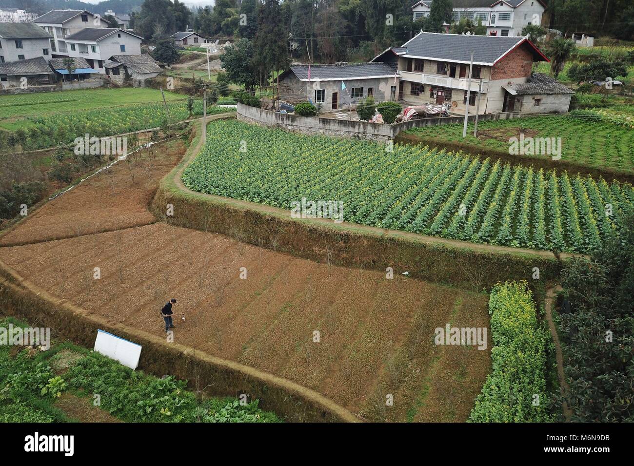 Suiyang. 5th Mar, 2018. Aerial photo taken on March 5, 2018 shows a man ...