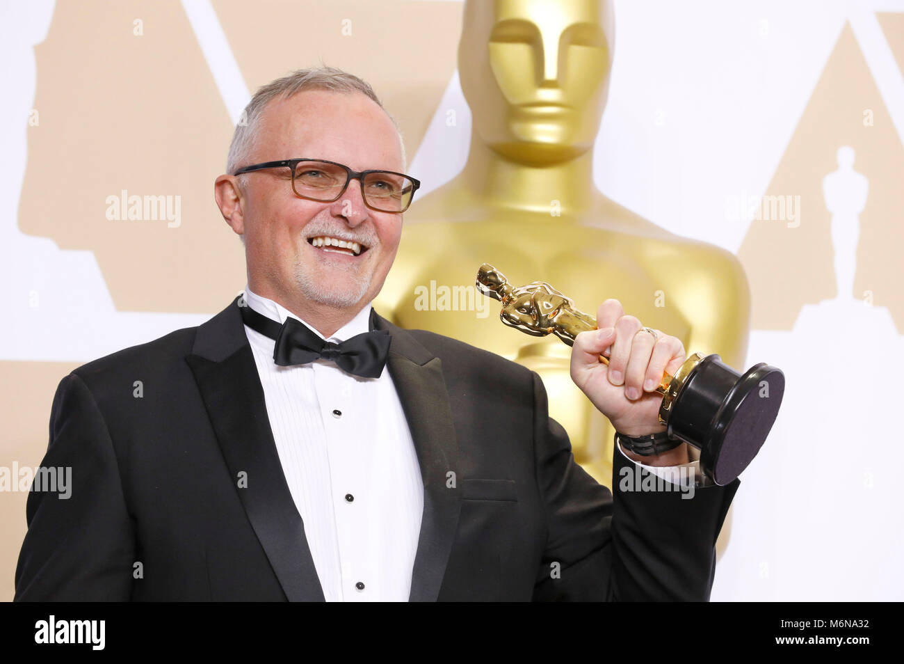 Lee Smith, award winner for 'Best Film Editing', pose in the press room ...