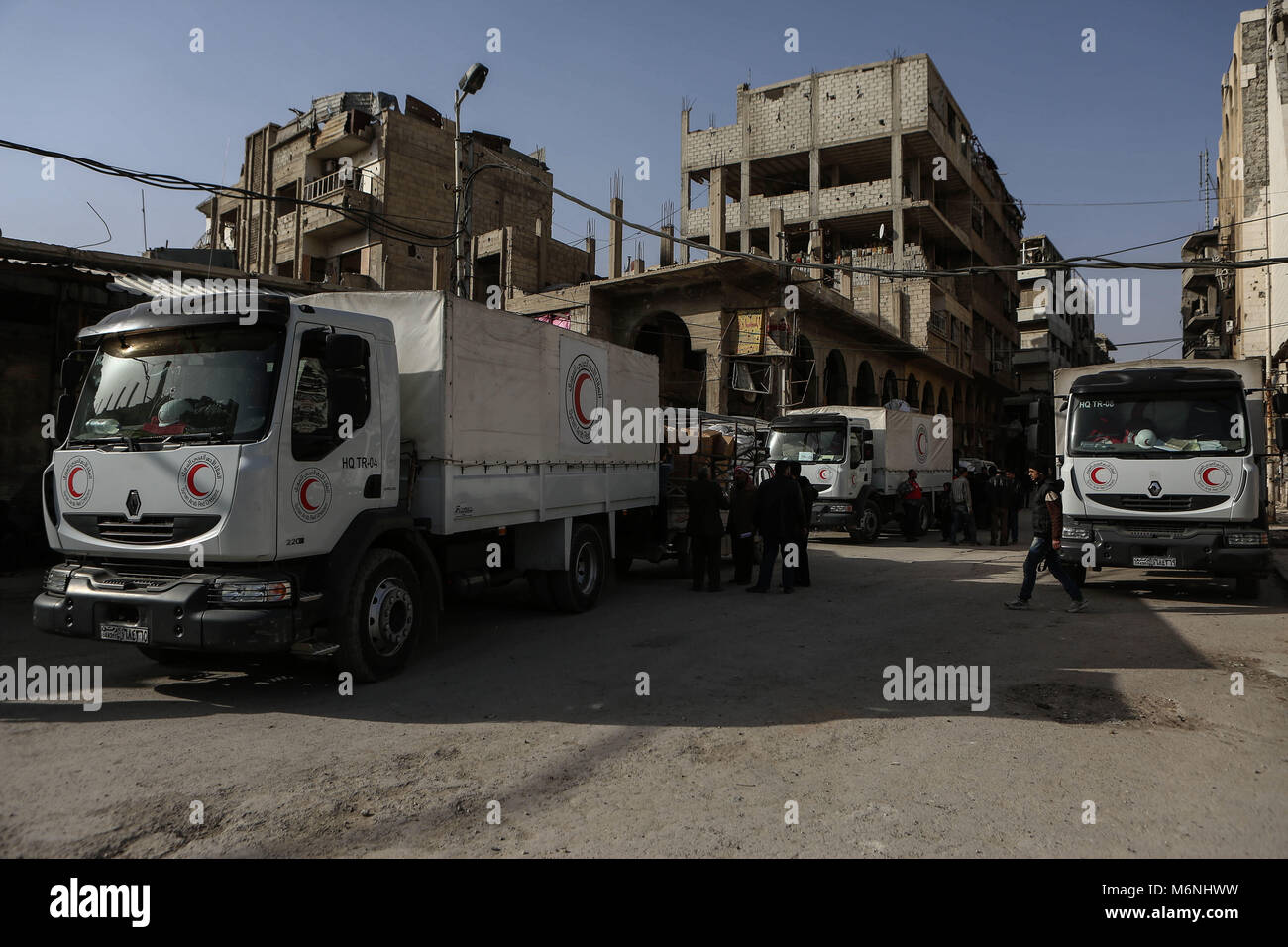 An aid convoy of the Syrian Arab Red Crescent arrives at the rebel-held ...