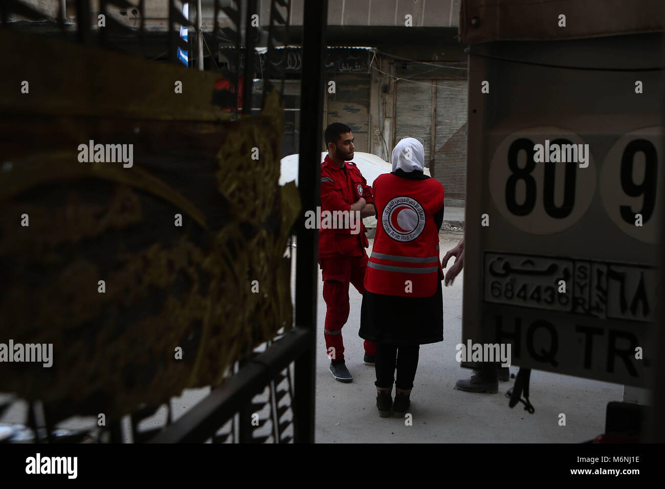 Members of the Syrian Arab Red Crescent prepare to deliver aid to the ...