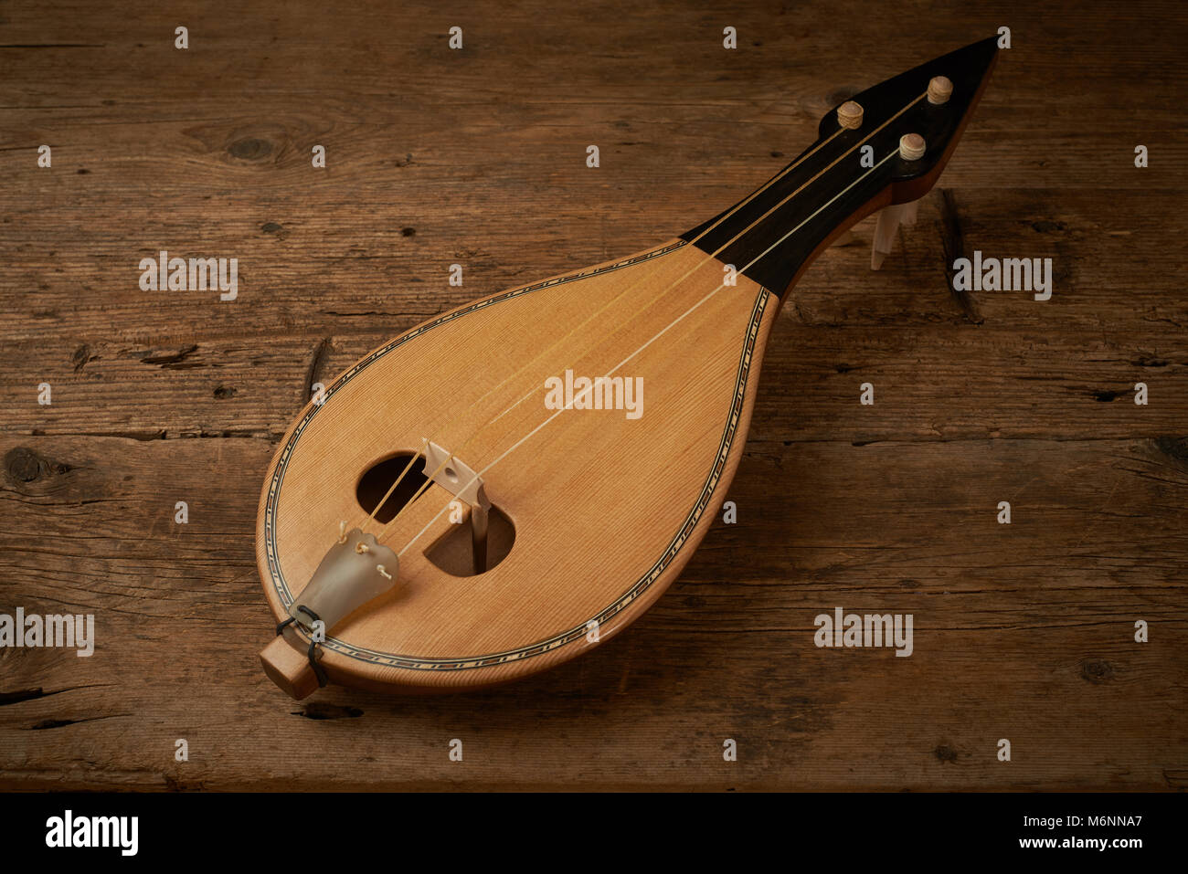 Traditional Greek instrument called Thrakian lyra on wooden background ...
