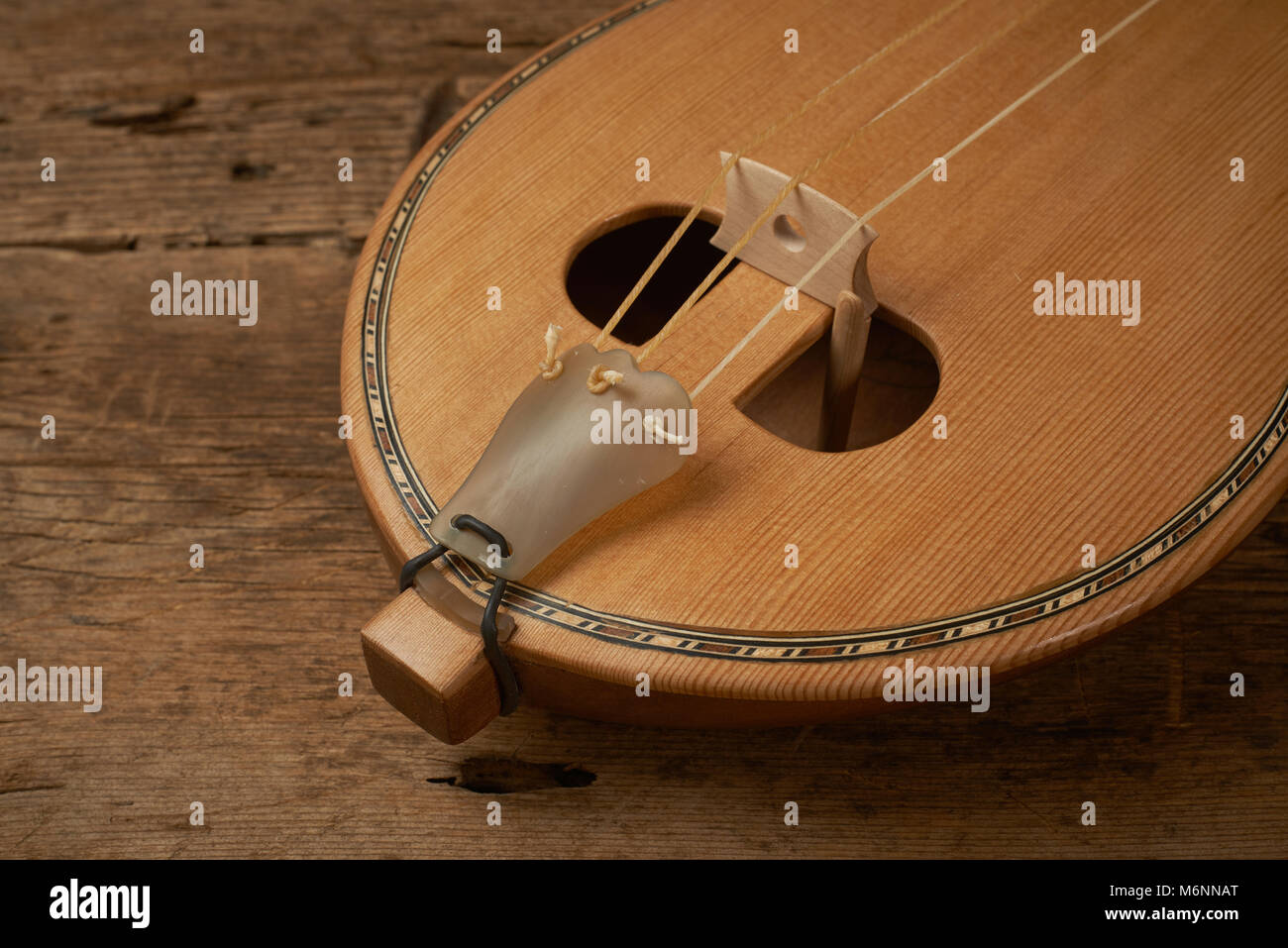 Traditional Greek instrument called Thrakian lyra on wooden background ...