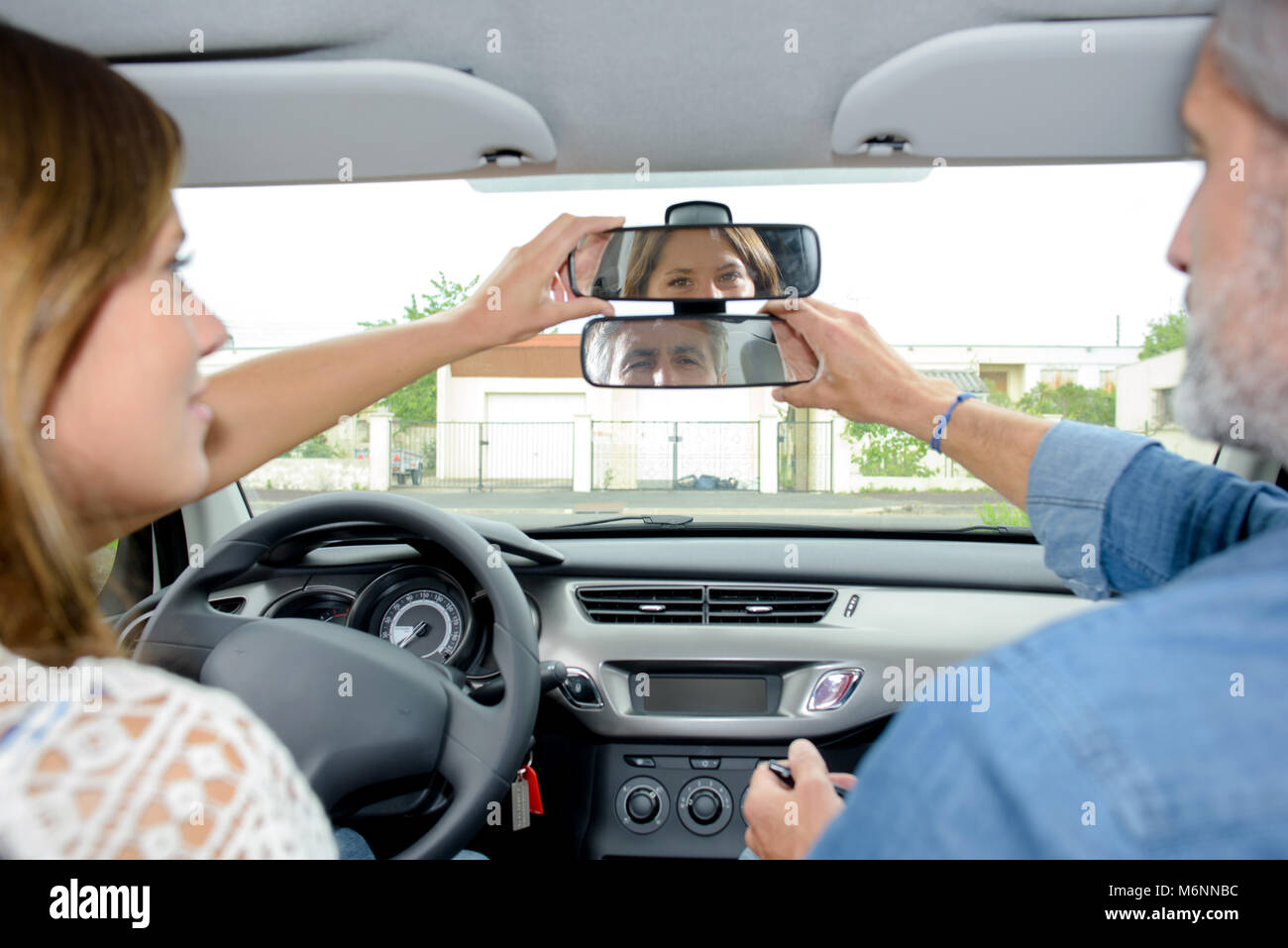 adjusting the rear-view mirrors Stock Photo - Alamy