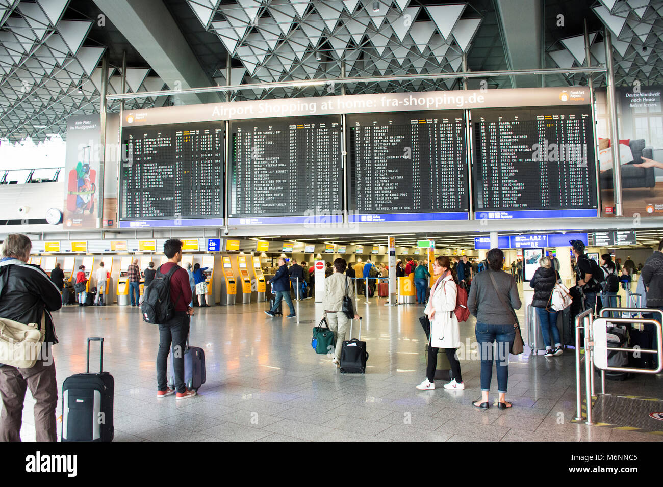German and foreigner traveler wait flight with passenger arriving and ...