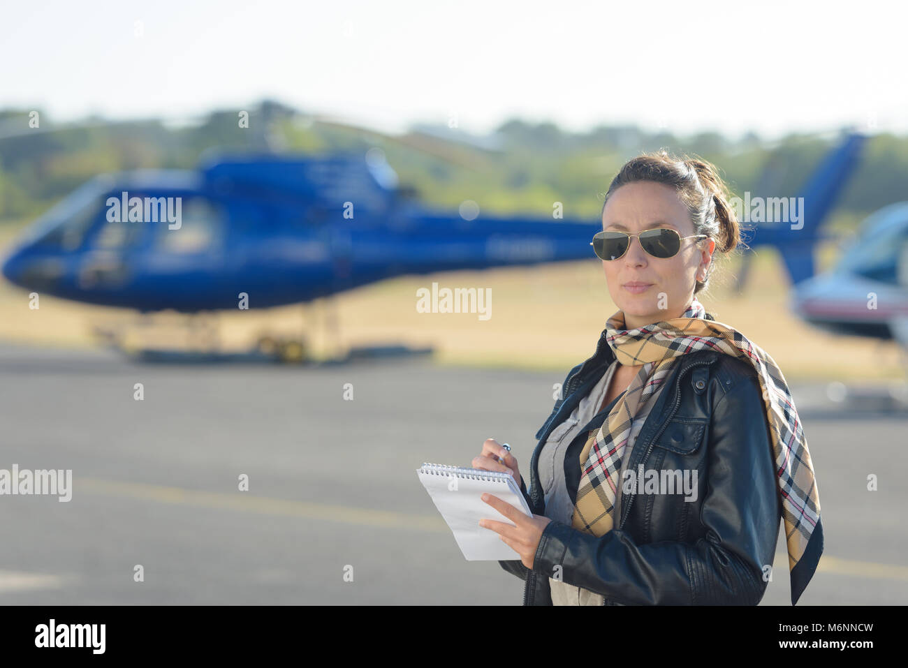 pretty pilot woman on helicopter background Stock Photo - Alamy