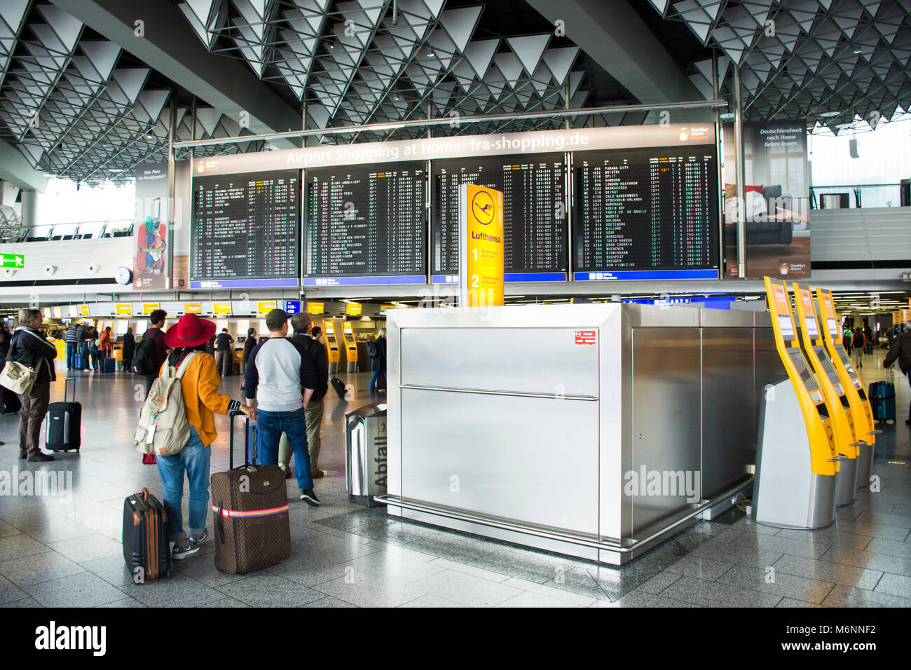 German and foreigner traveler wait flight with passenger arriving and ...