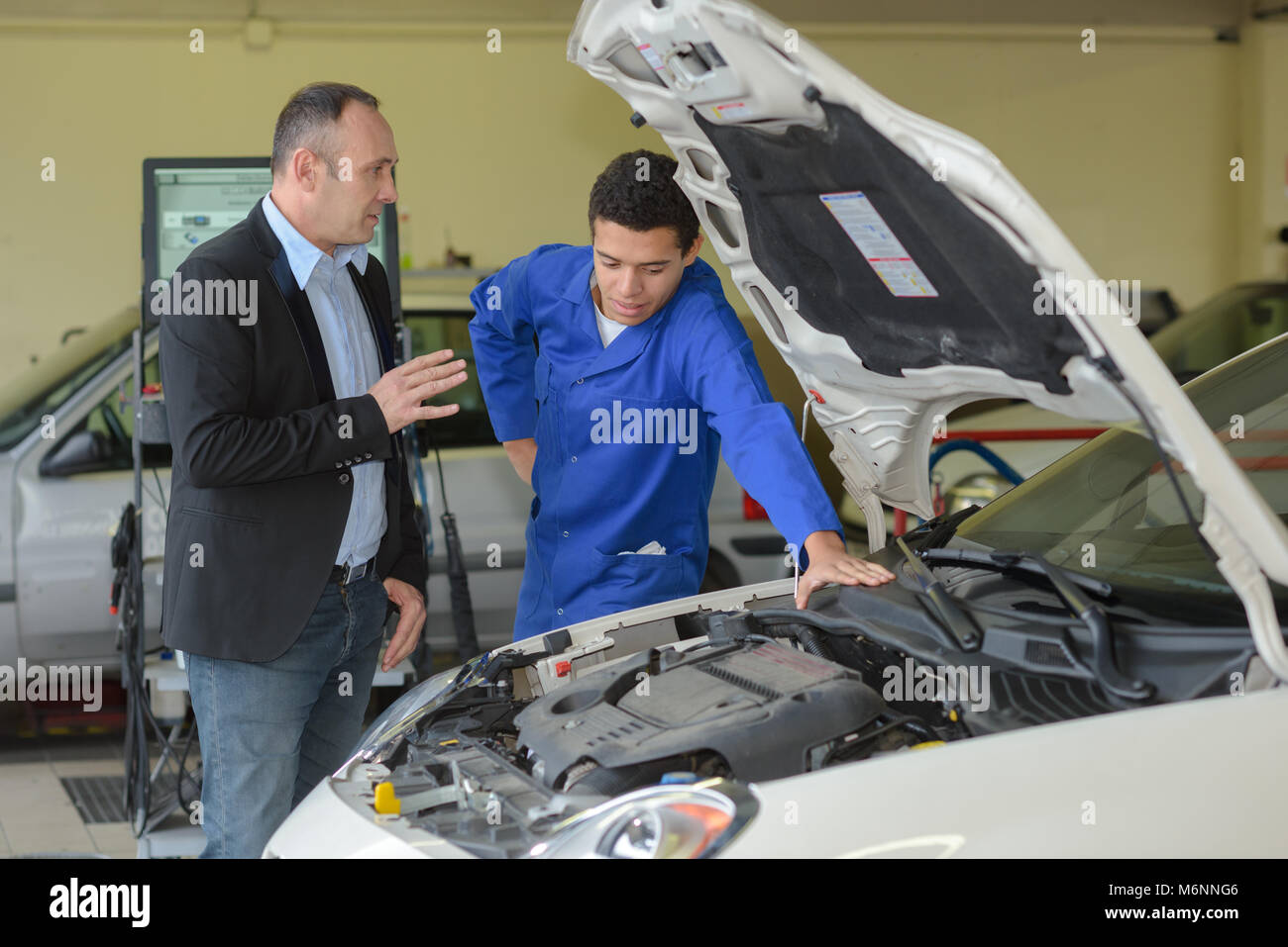 car mechanic talking with customer Stock Photo - Alamy