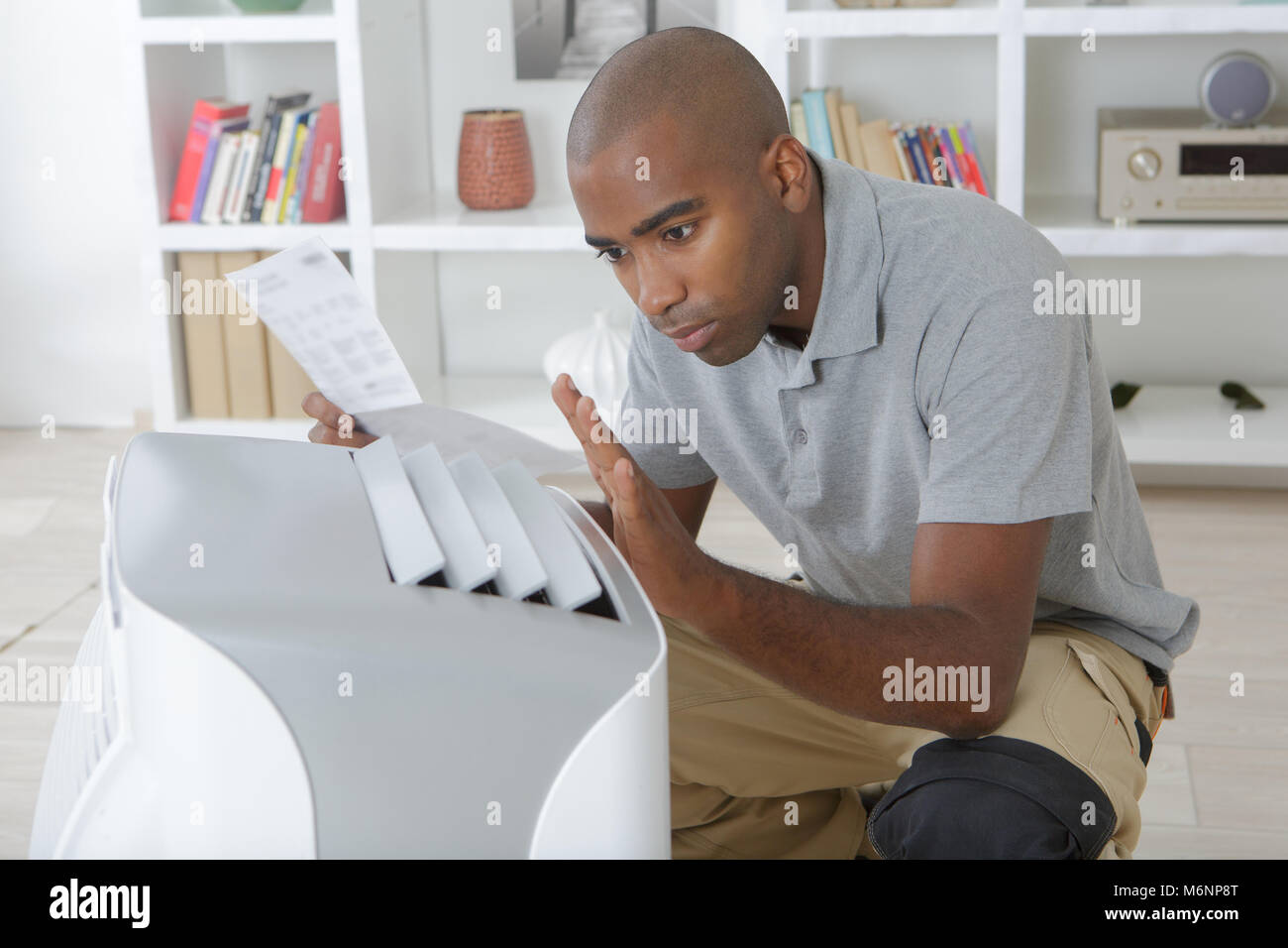 Man reading instructions for home air conditioning unit Stock Photo - Alamy