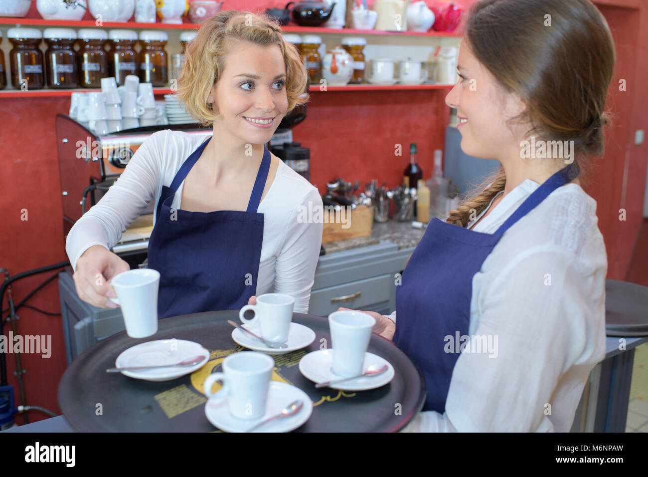 two waitresses posing in coffee house in uniform Stock Photo - Alamy