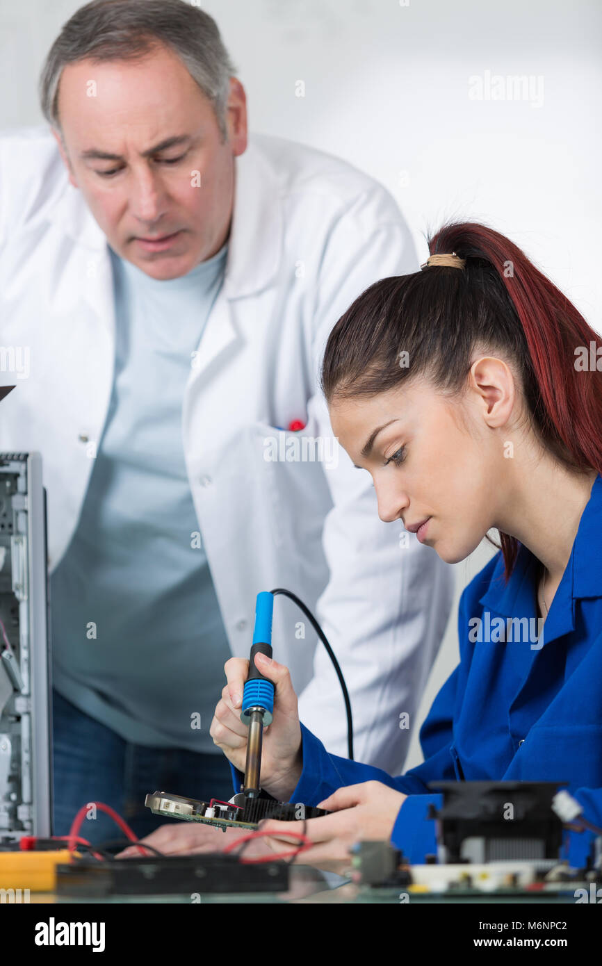 young woman student repairing electronics device Stock Photo - Alamy