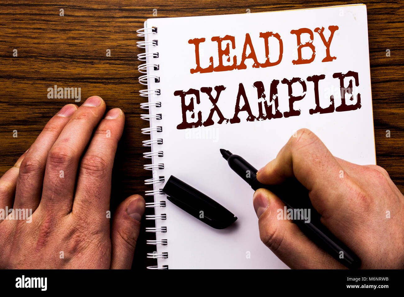 Handwritten text showing word Lead By Example. Business concept for ...