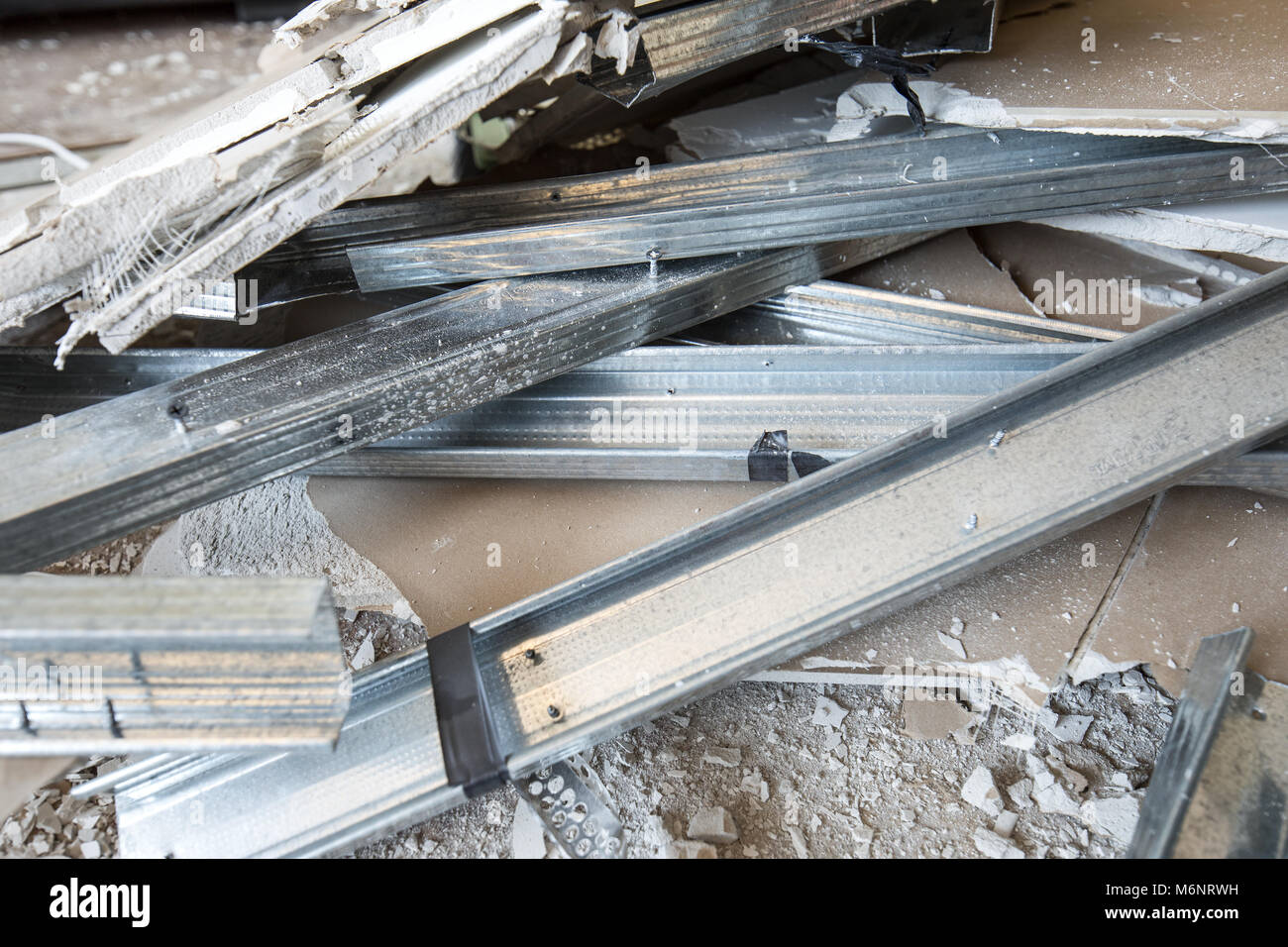 Heaps of rubble, pices of gypsum plasterboard and mounting rails. Mess ...