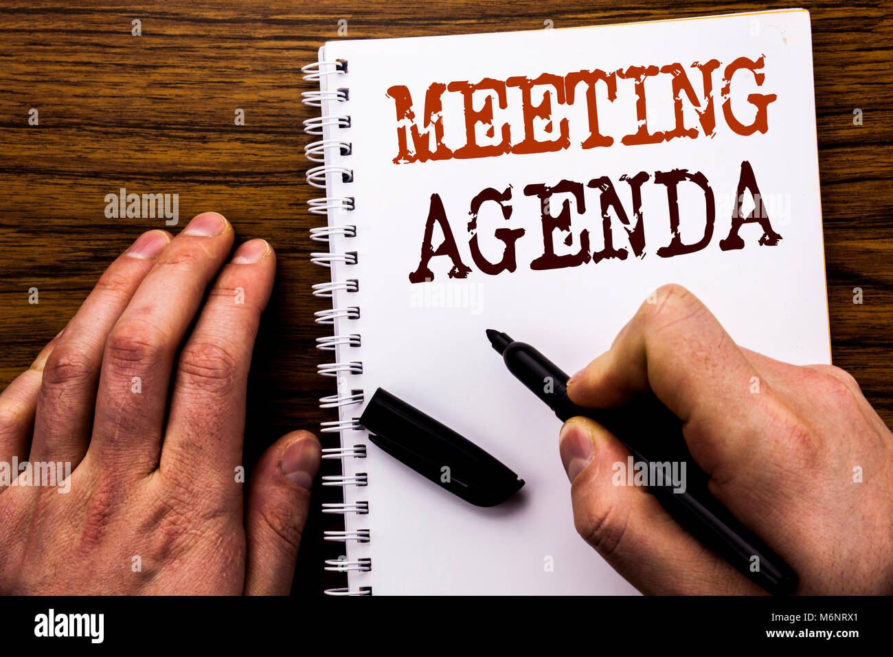 Handwritten text showing word Meeting Agenda. Business concept for ...