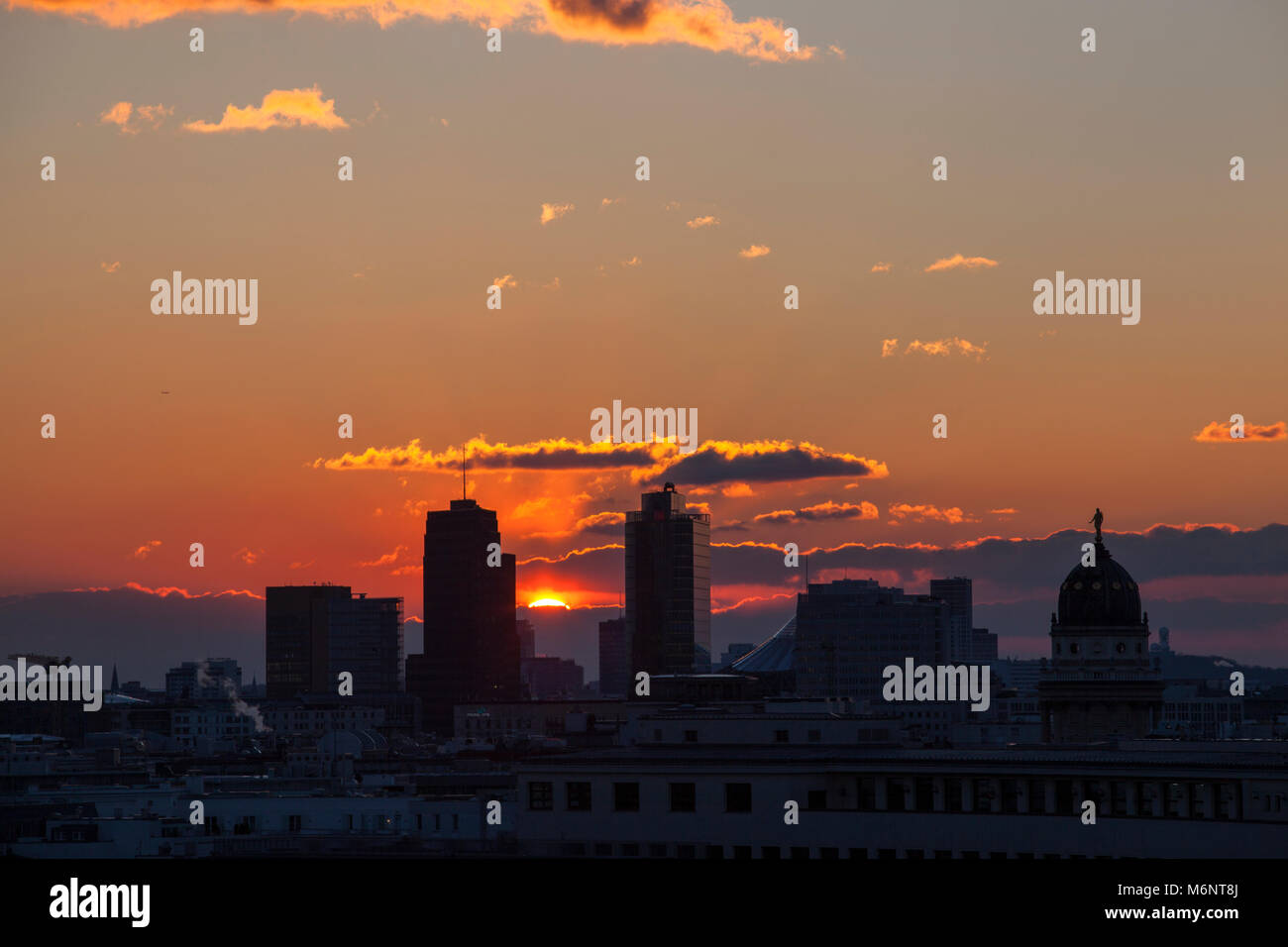 Potsdammer Platz silhouetted against setting sun in Berlin, Germany ...