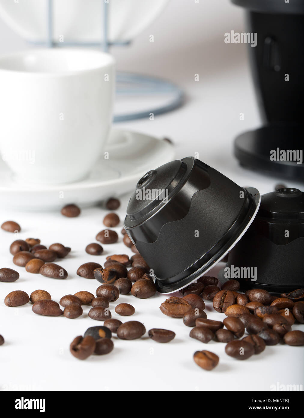 Coffee capsules and coffee beans. Closeup Stock Photo - Alamy