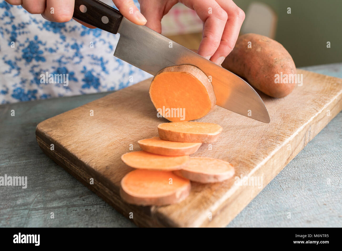 Woman cutting potato hi-res stock photography and images - Alamy