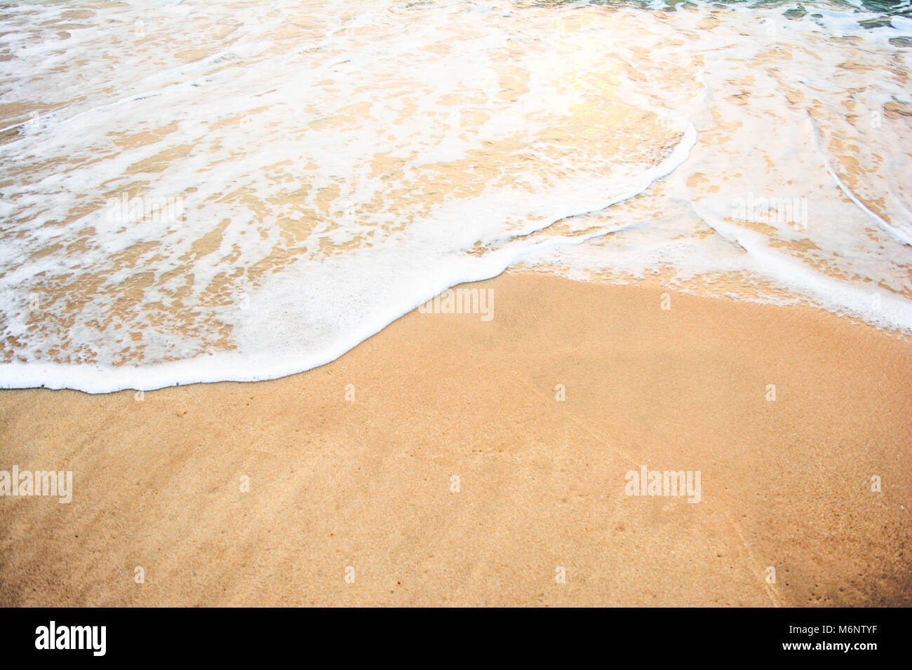ocean wave on sandy beach Stock Photo - Alamy