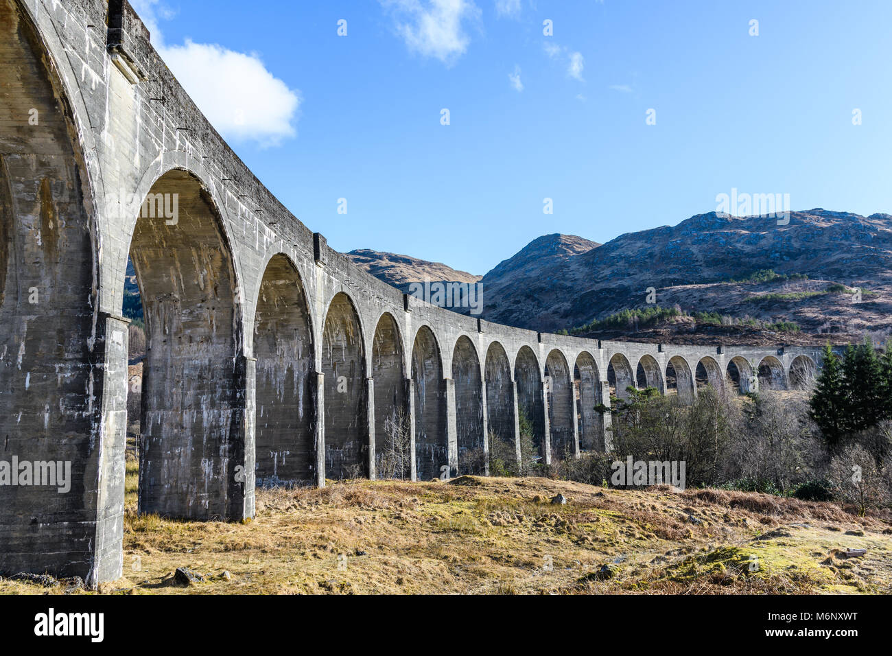 The stone railway viaduct in the highlands of Scotland at the valley of ...