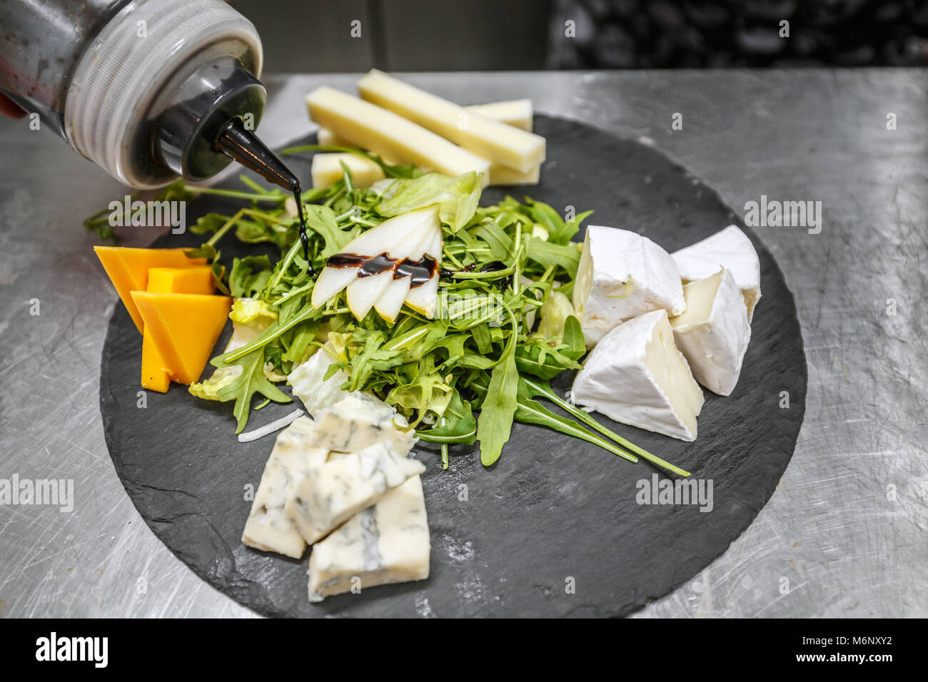 The chef prepares the meal. Pour sauce and decorate the dish Stock ...