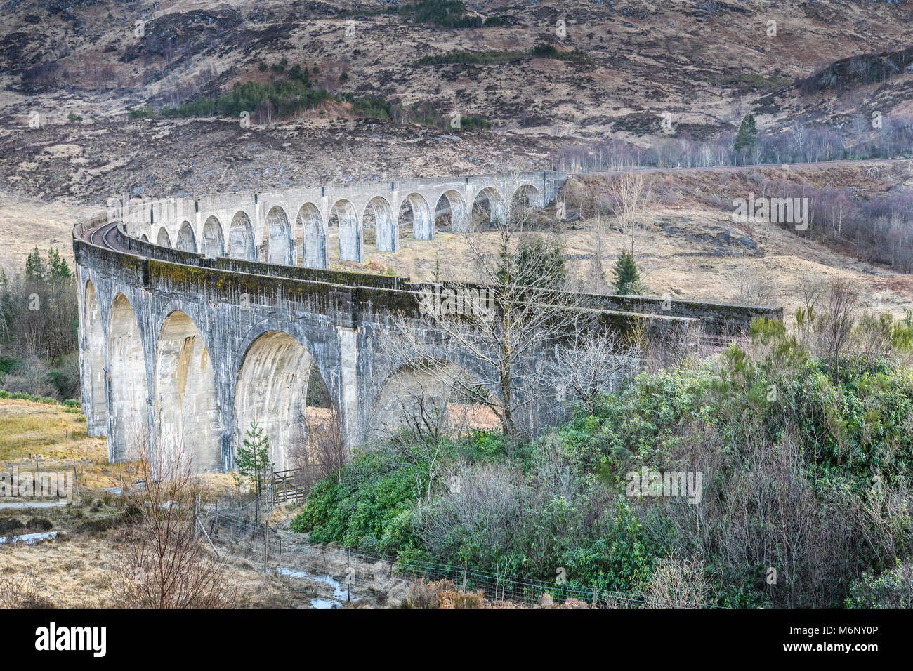 The stone railway viaduct in the highlands of Scotland at the valley of ...