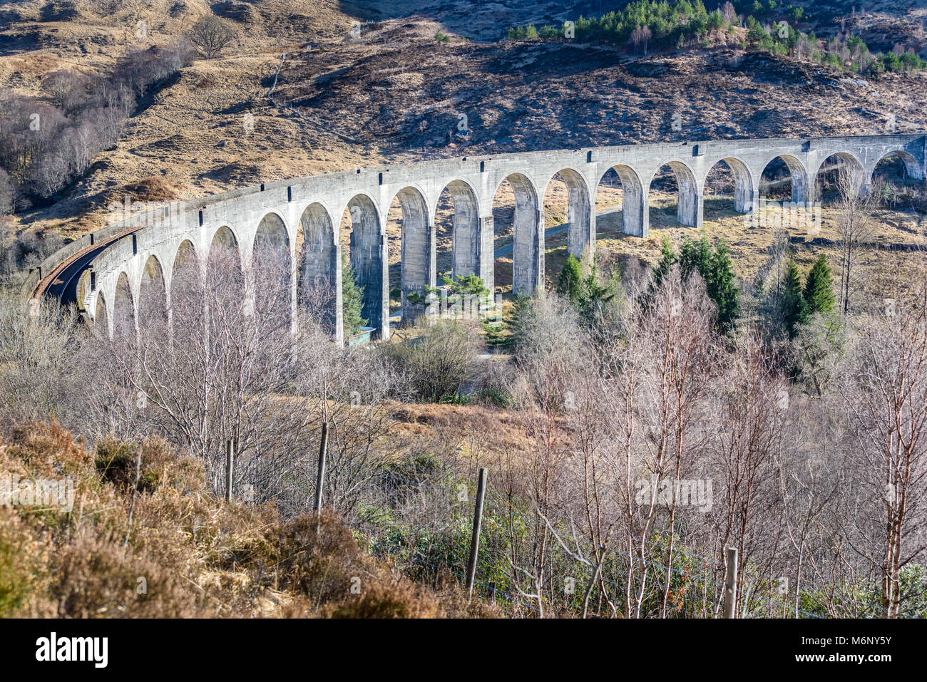 The stone railway viaduct in the highlands of Scotland at the valley of ...