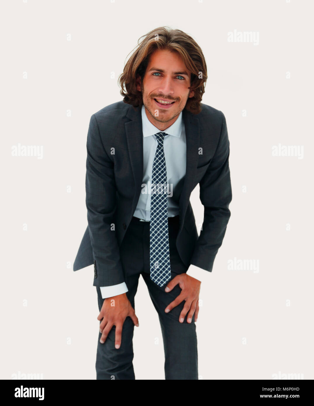 Young handsome businessman bending down Stock Photo - Alamy