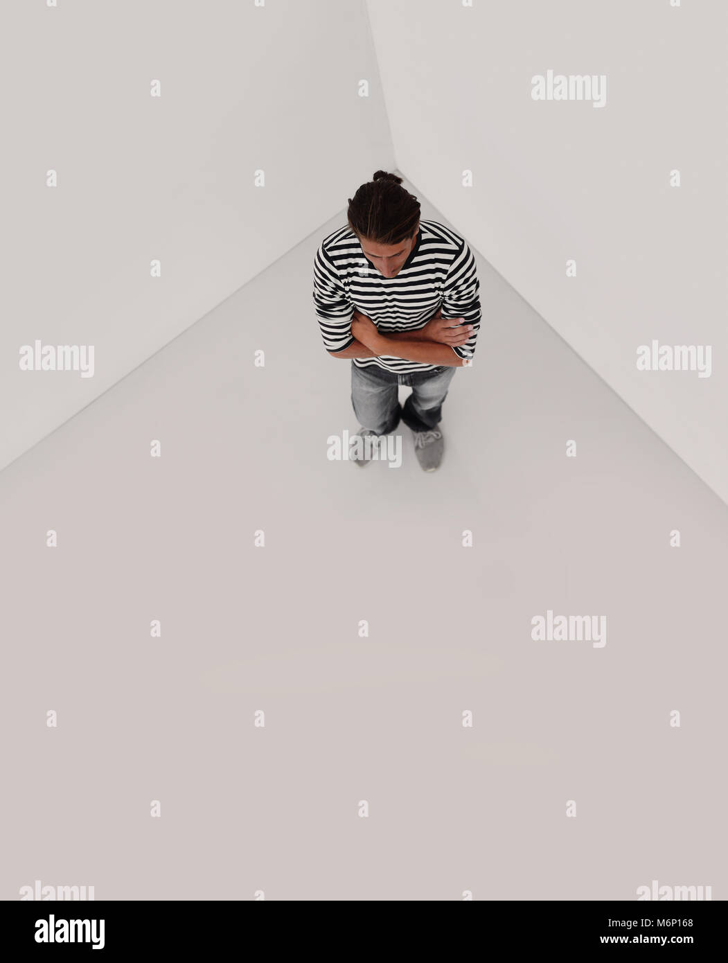 handsome guy standing near the white wall Stock Photo - Alamy