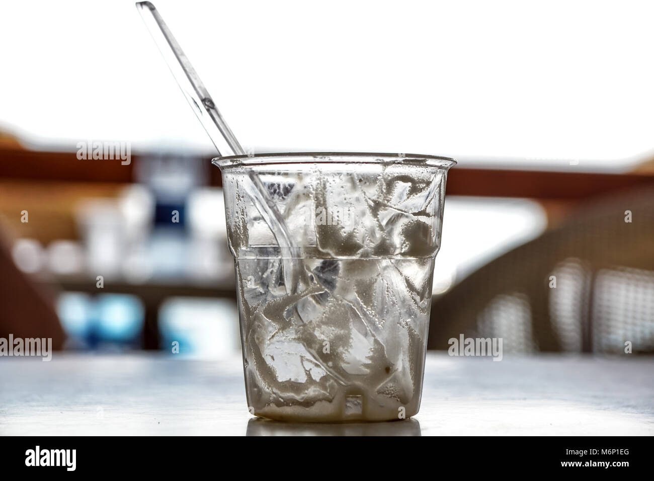 cocktail glass or empty drink is used with drops of foam on a table ...