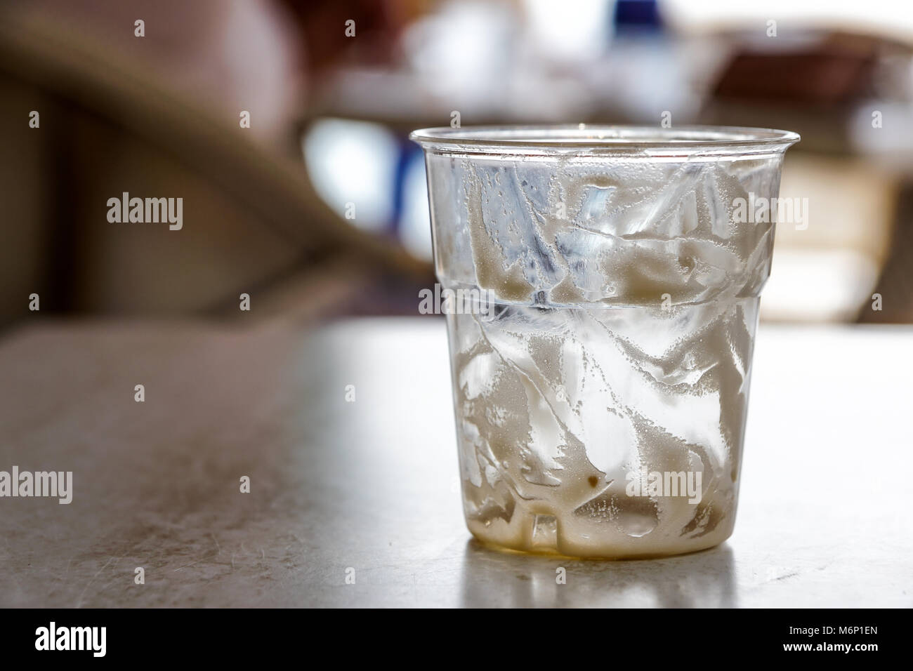 cocktail glass or empty drink is used with drops of foam on a table ...