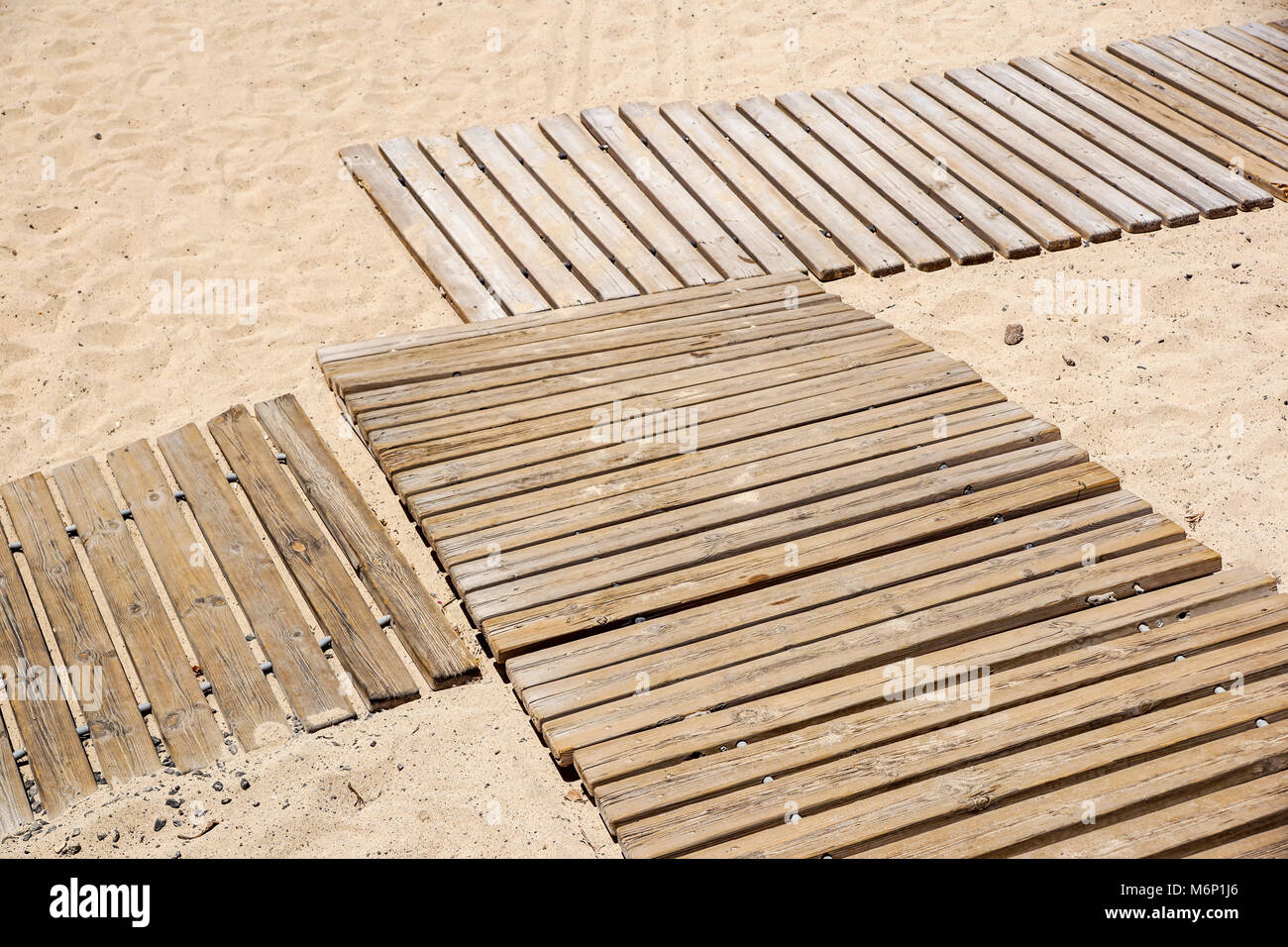 Wooden floor on golden sandy beach Stock Photo - Alamy