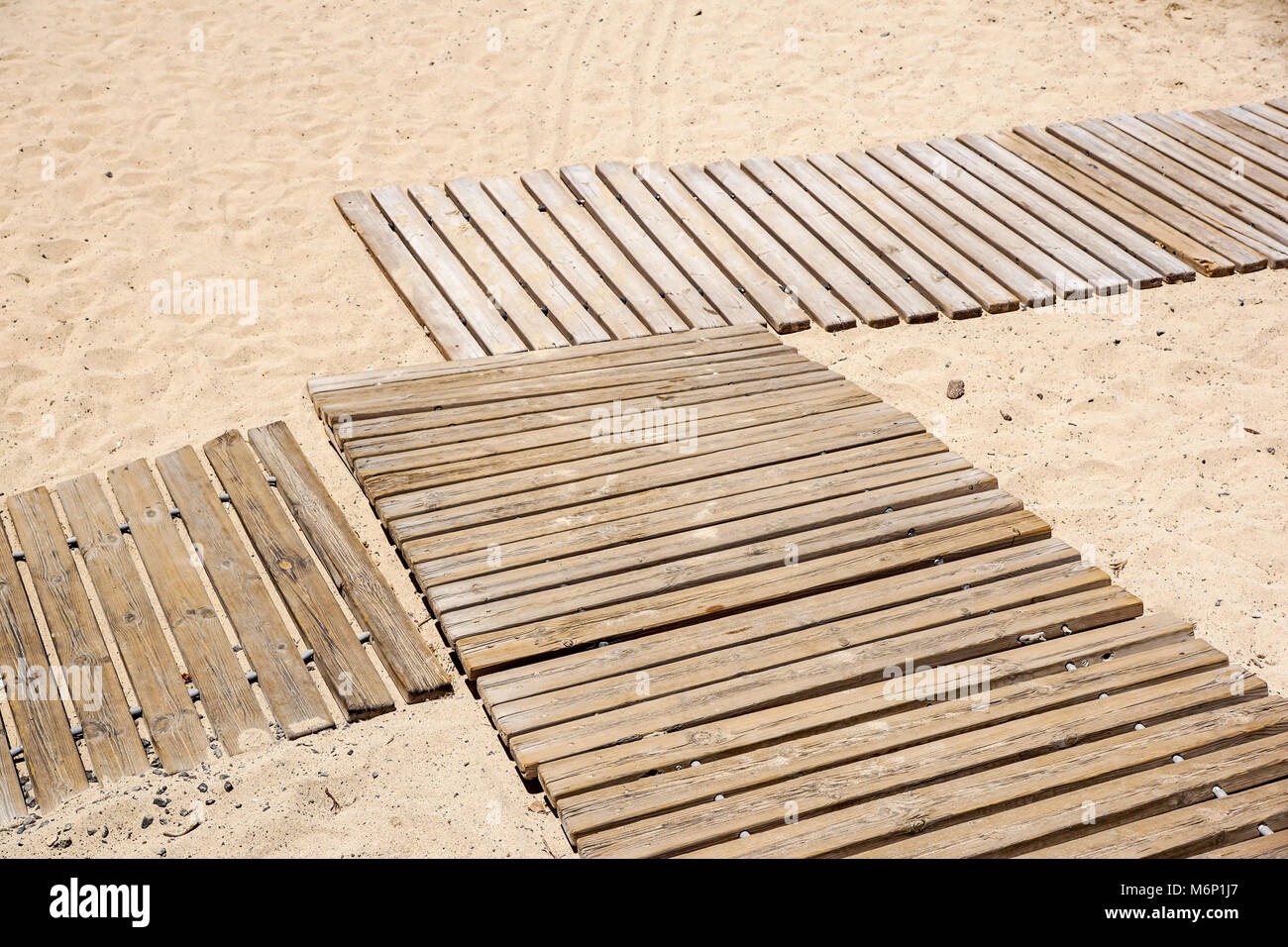 Wooden floor on golden sandy beach Stock Photo - Alamy