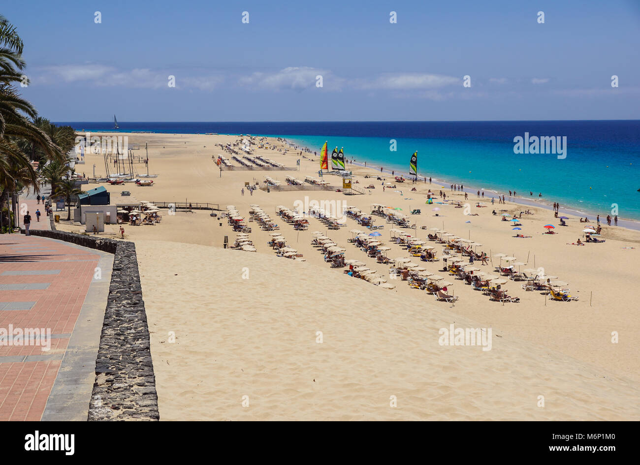 Sand dune and coastal promenade along a beach in Morro Jable town ...