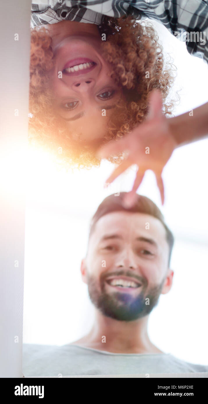 View from below husband and wife looking inside the box Stock Photo - Alamy