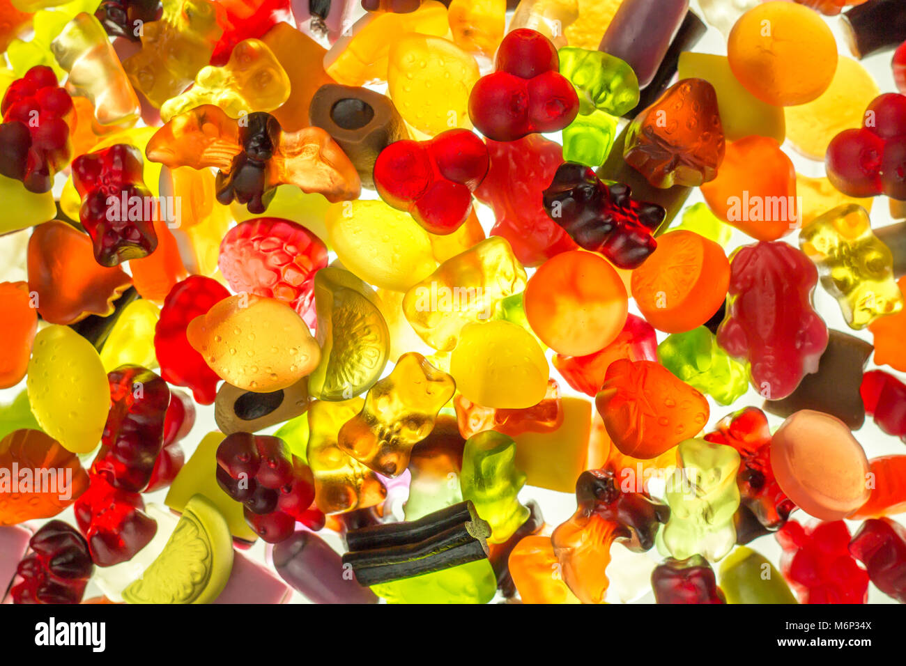 colorful fruit gums mix bright translucent on illuminate underground ...