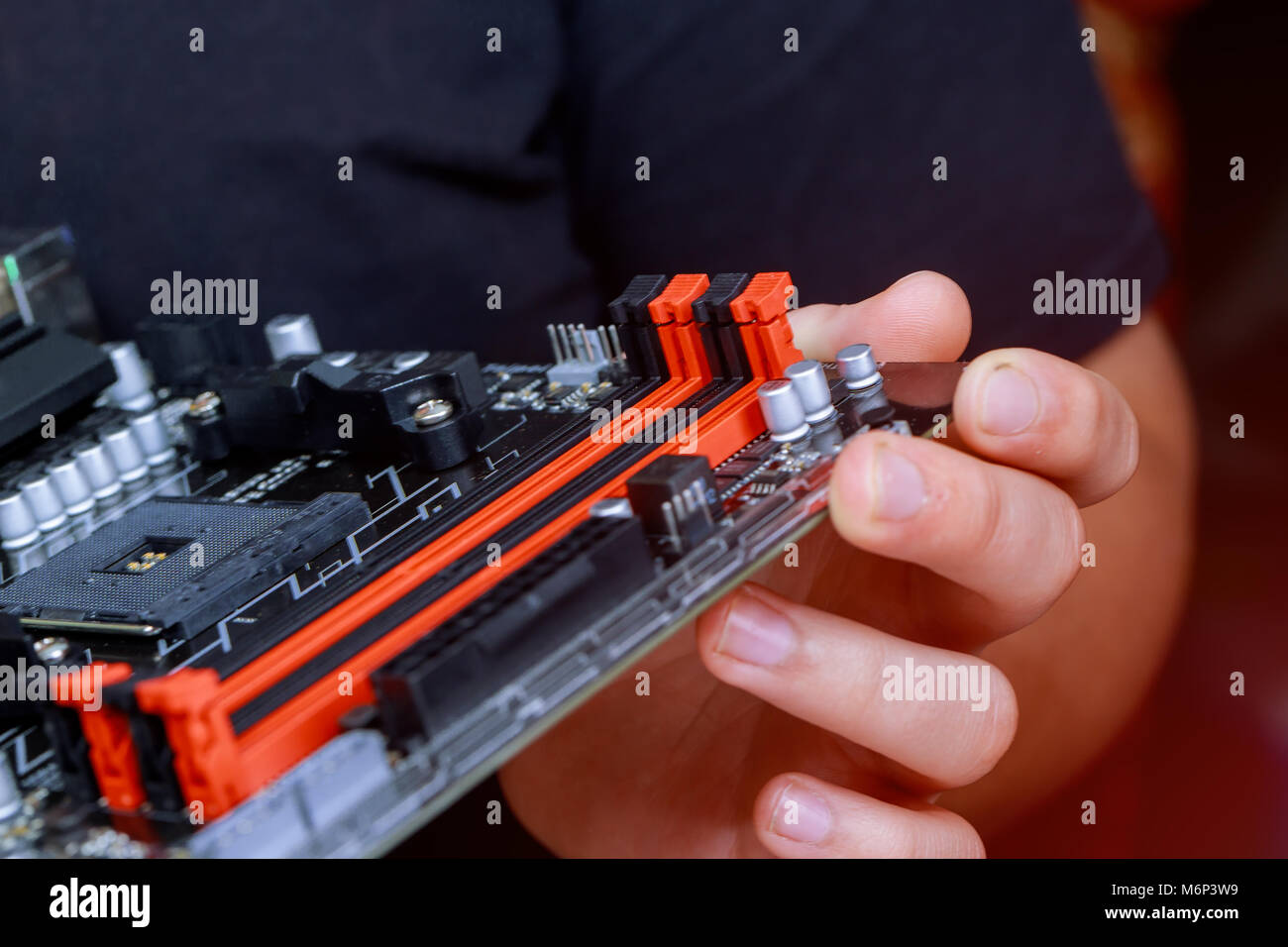 The engineer installing Memory RAM on Motherboard Computer in computer ...