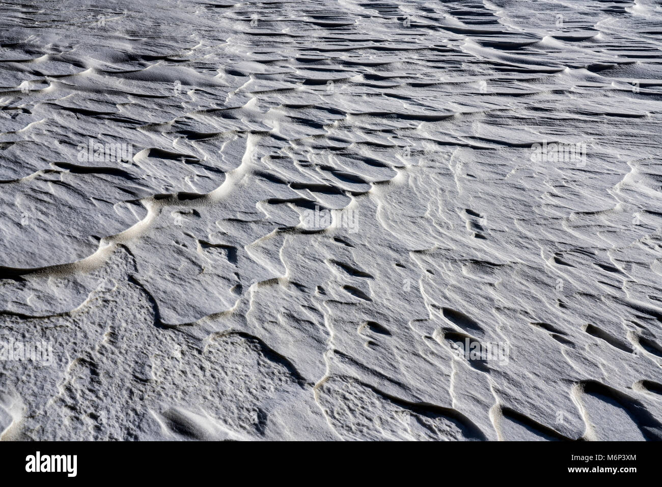 Patterns in wind blown snow on a frozen river in Alaska Stock Photo - Alamy