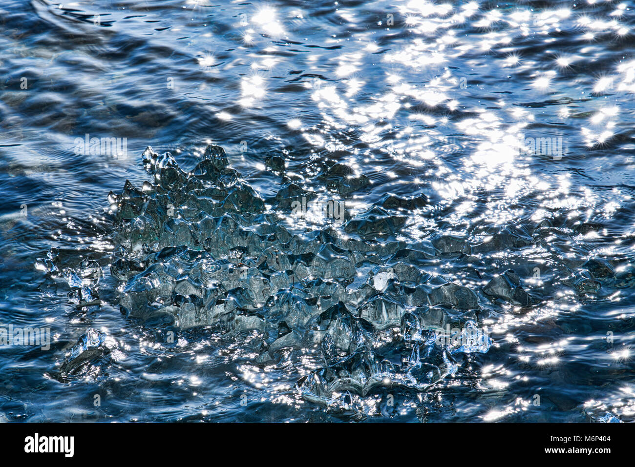 Floating chunk of sea ice sparkling in the sun Stock Photo - Alamy