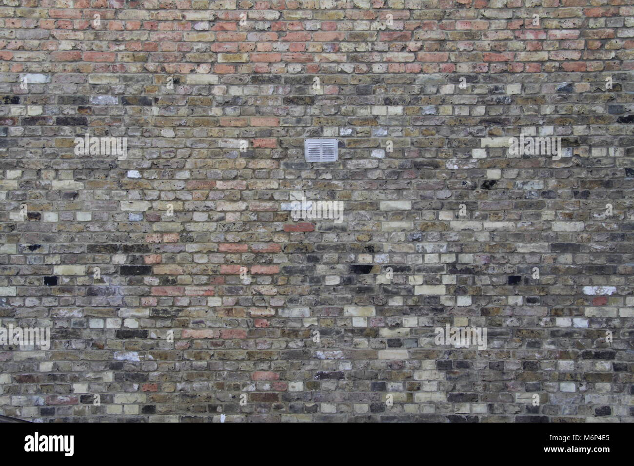 Brickwall background with T shape variance in brick type and small vent ...