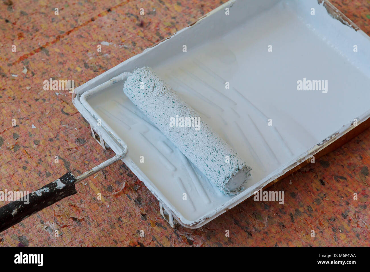 close up details of painting walls, industrial worker using roller and ...