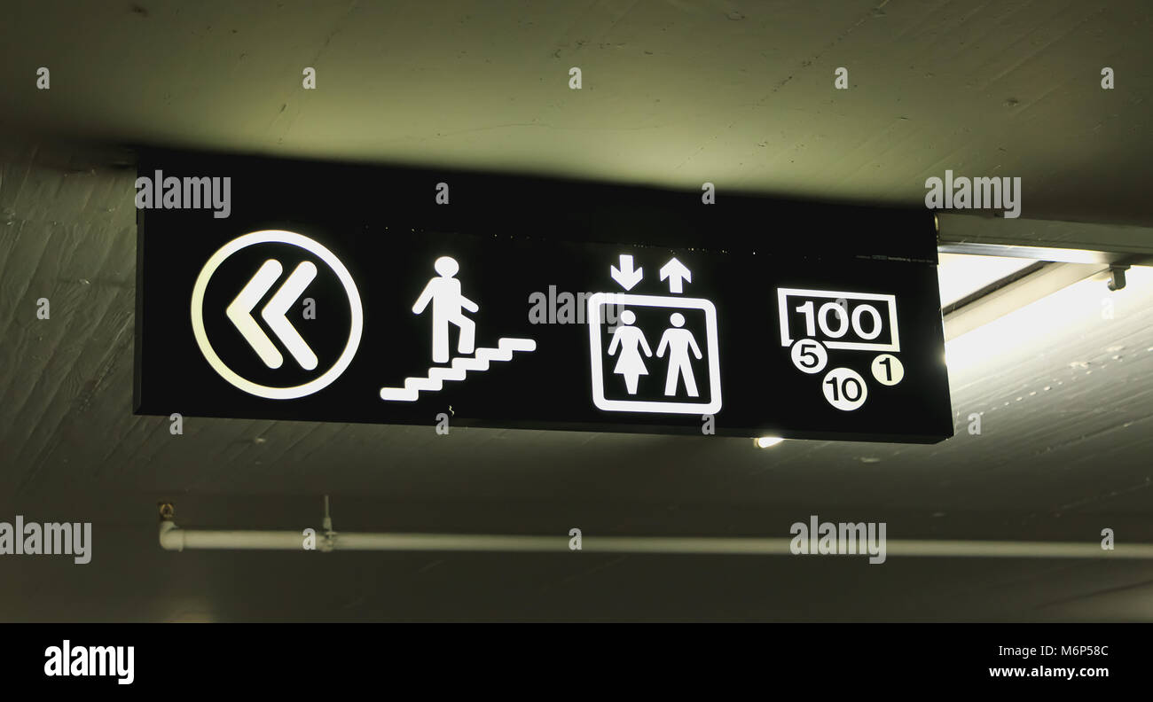 illuminated signs that indicates the direction of the stairs elevator ...