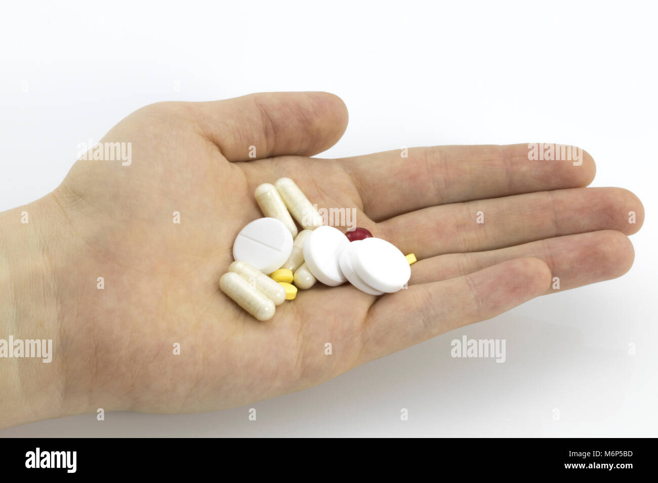 Medicine pills or capsules in hand, palm or fingers of a doctor or ...
