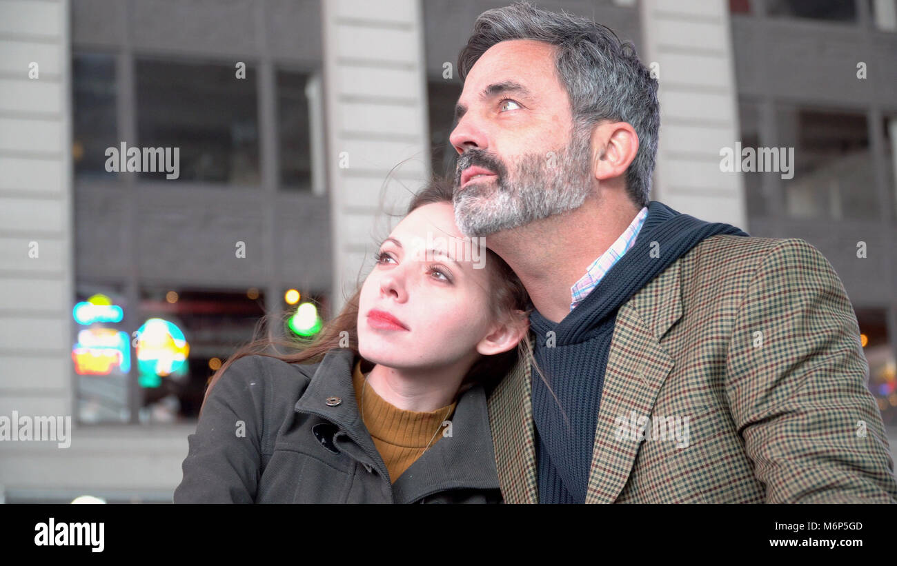 Attractive happy young couple in love embracing in each other arms ...