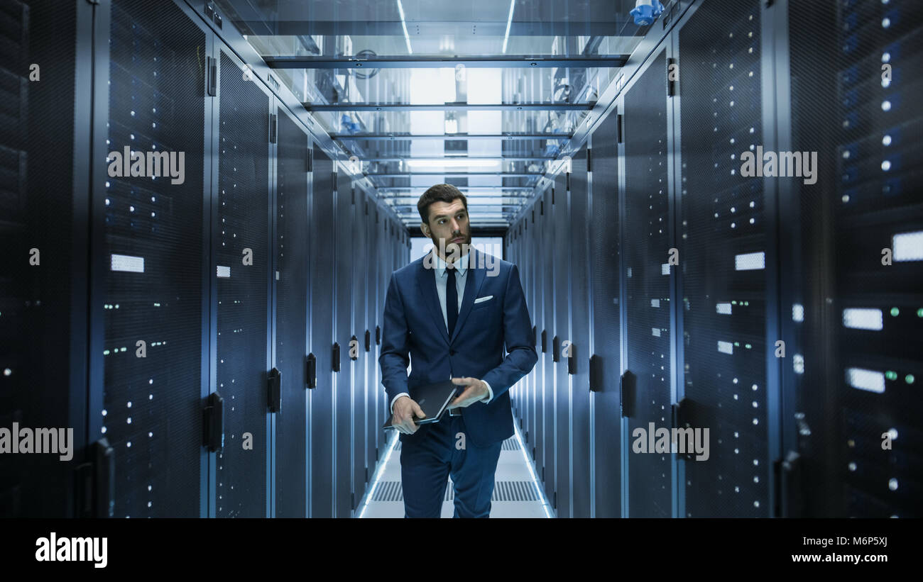 Data Center Technician Walking Through Server Rack Corridor Visually ...