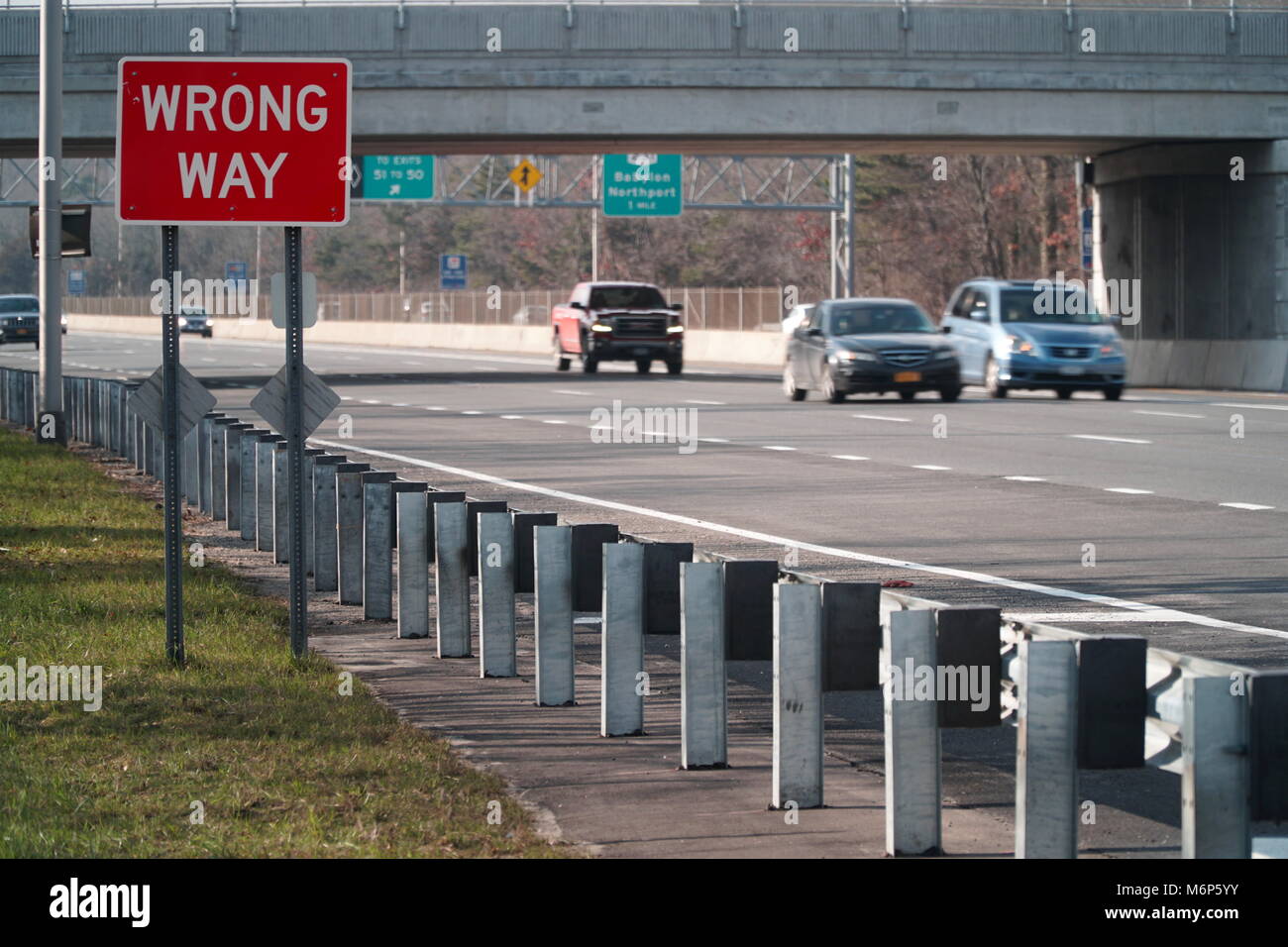 Wrong Way caution safety sign posted along a major interstate highway ...