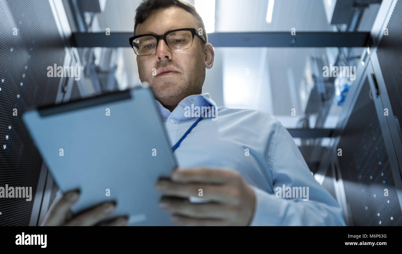 Server Technician Working in Data Center. They Walk Through Working ... Server Technician Working in Data Center. They Walk Through Working ...