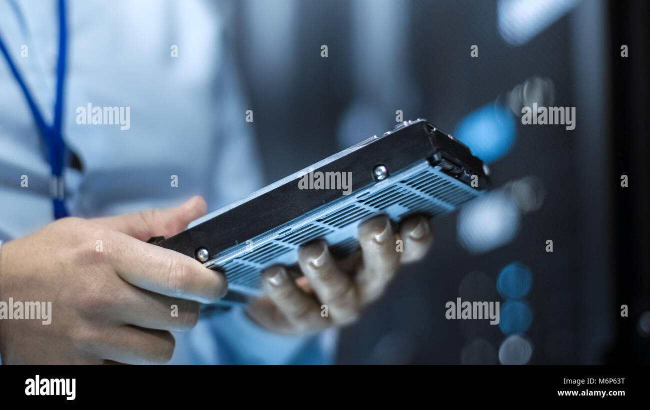 In Fully Working Data Center IT Engineer is Holding Hard Drive ...