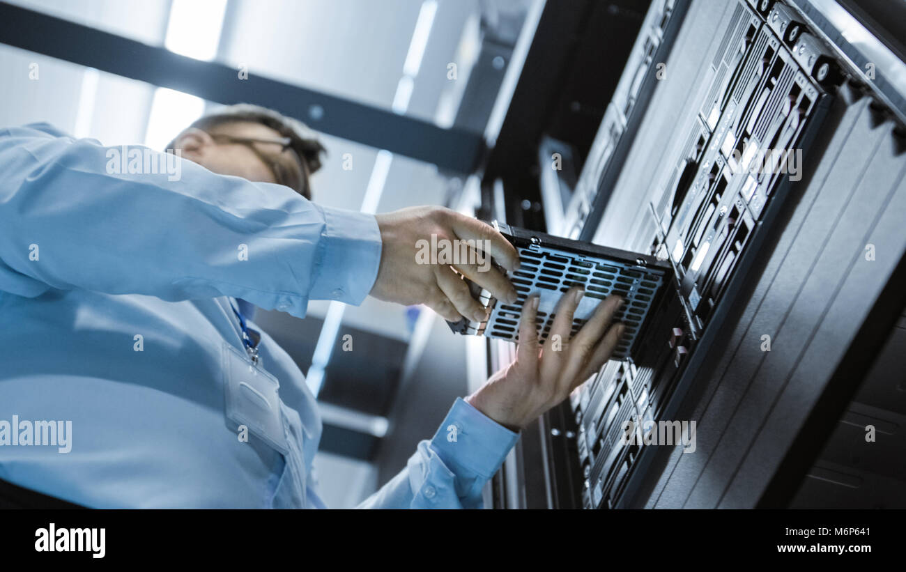 Low Angle Shot In Fully Working Data Center IT Engineer Installs Hard ...